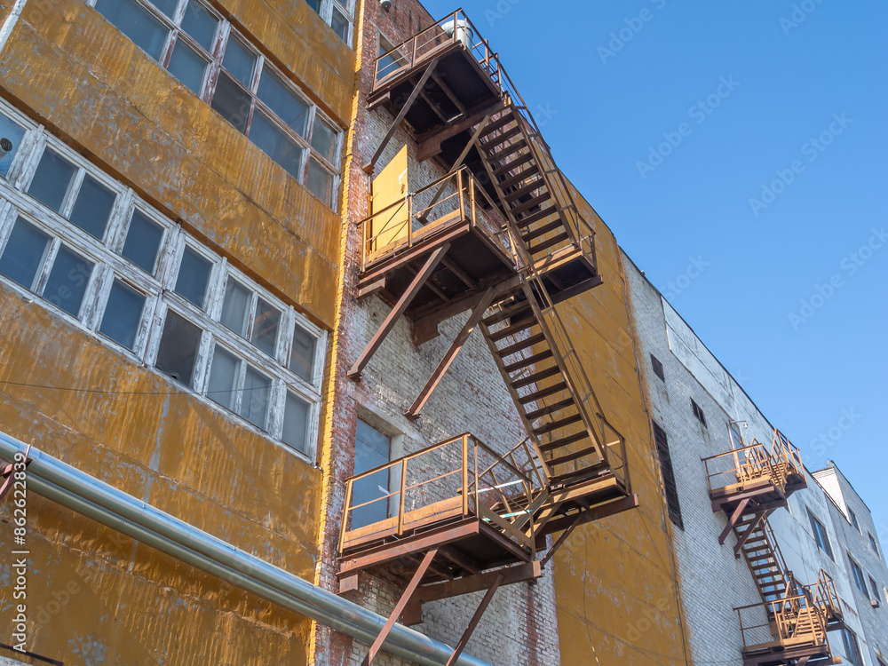 External stairs of industrial buildings. Escape ladders outside ...