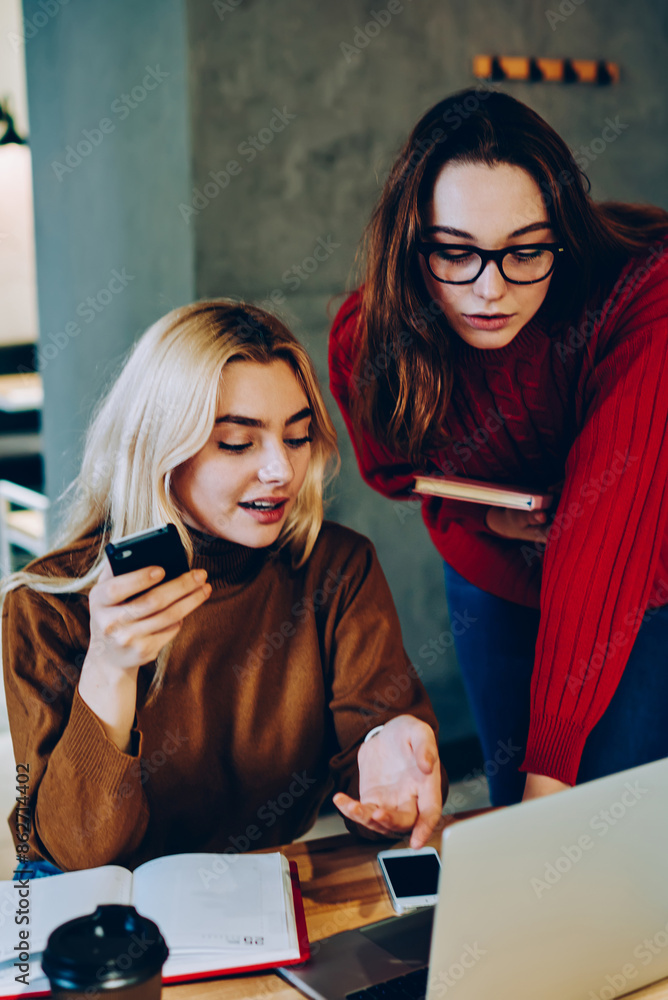 Smart female students watching tutorial on laptop computer planning ...