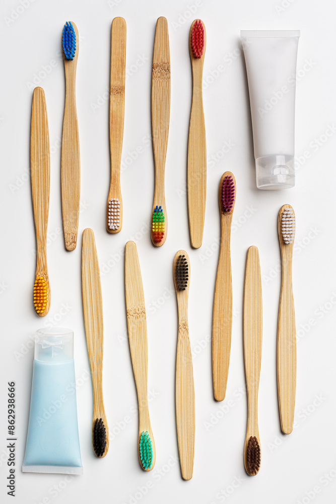Colorful bamboo toothbrushes and white toothpaste tube, eco-friendly ...