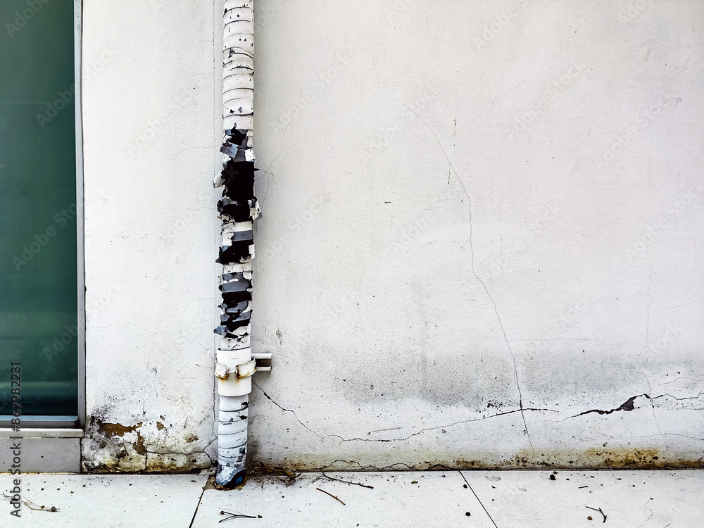 Old air conditioner drain hose with broken insulation. Air conditioning ...