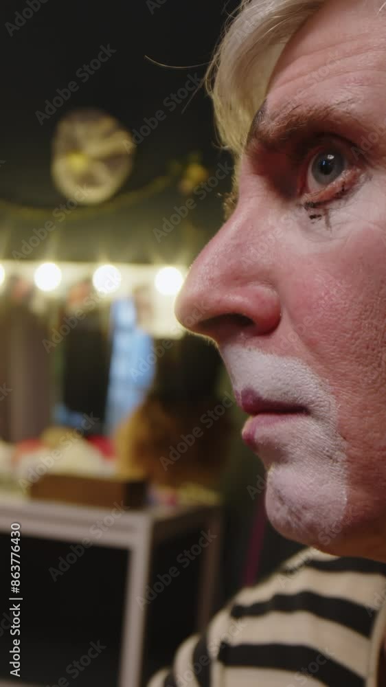 Vertical close-up of surprised face of Caucasian middle-aged clown ...