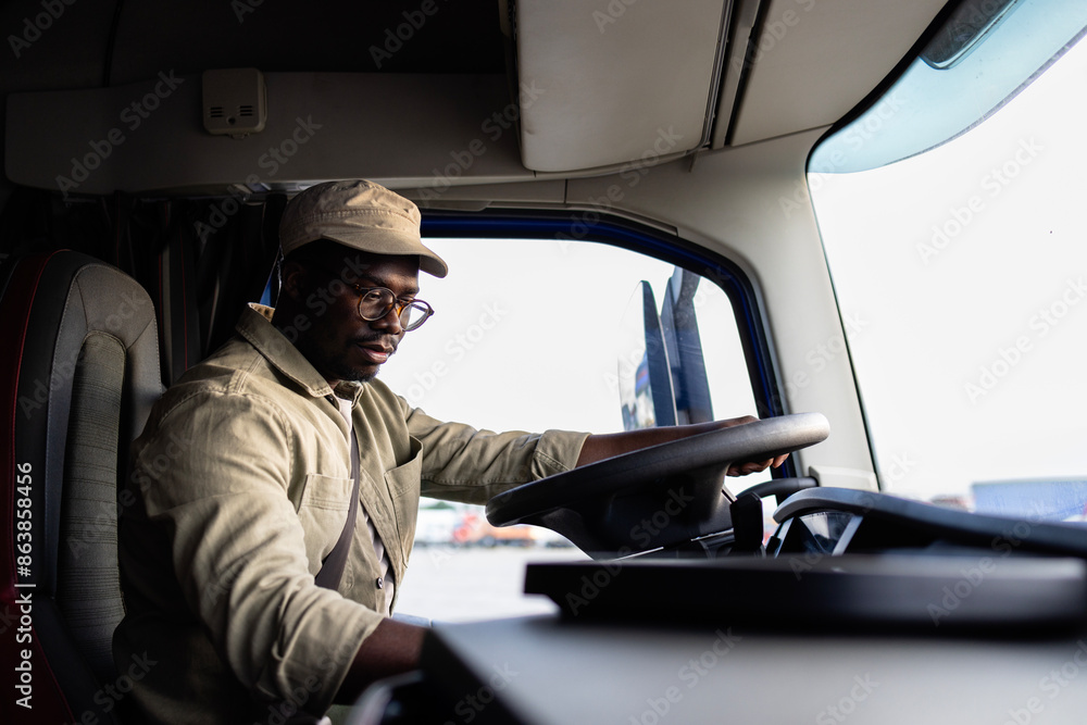 Professional driver sitting in truck cabin and driving. Stock Photo ...