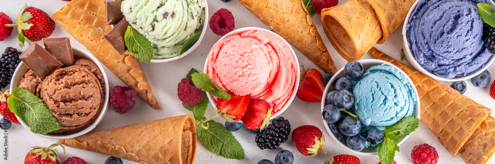 Colorful bright ice cream on bowls, with waffle cones and berries, on ...