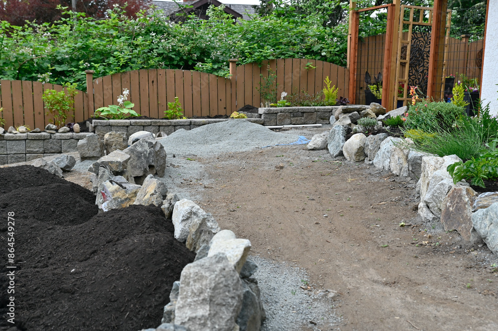 Yard garden landscaping project in progress, building rock borders ...