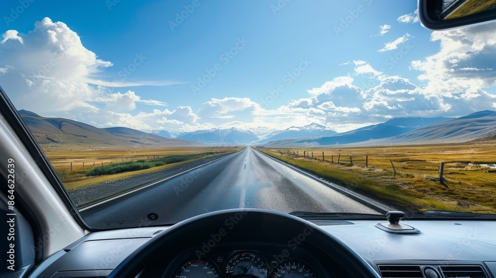 The road stretches out through the windshield of the car with the ...