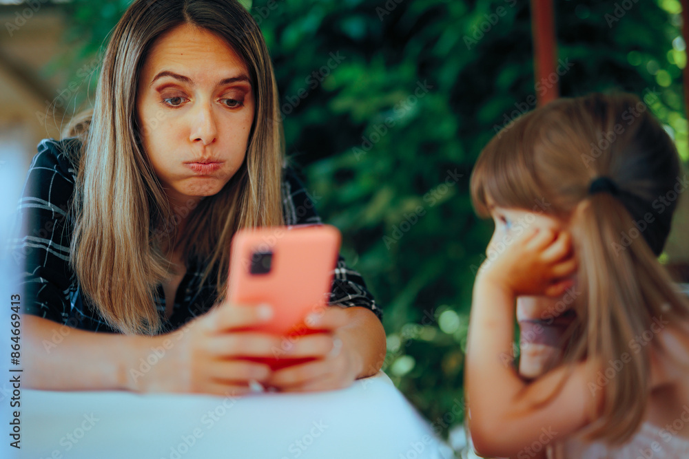 Mom Checking her Phone while Sitting next to her Daughter. Mother ...