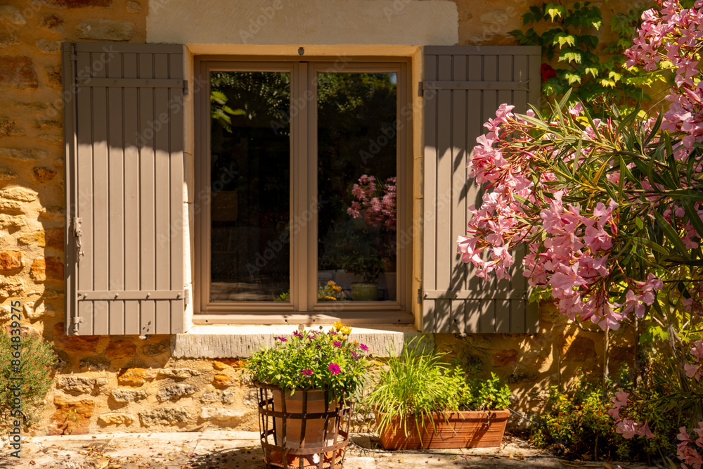 Mediterranean ambience: Window with wooden shutters decorated with ...