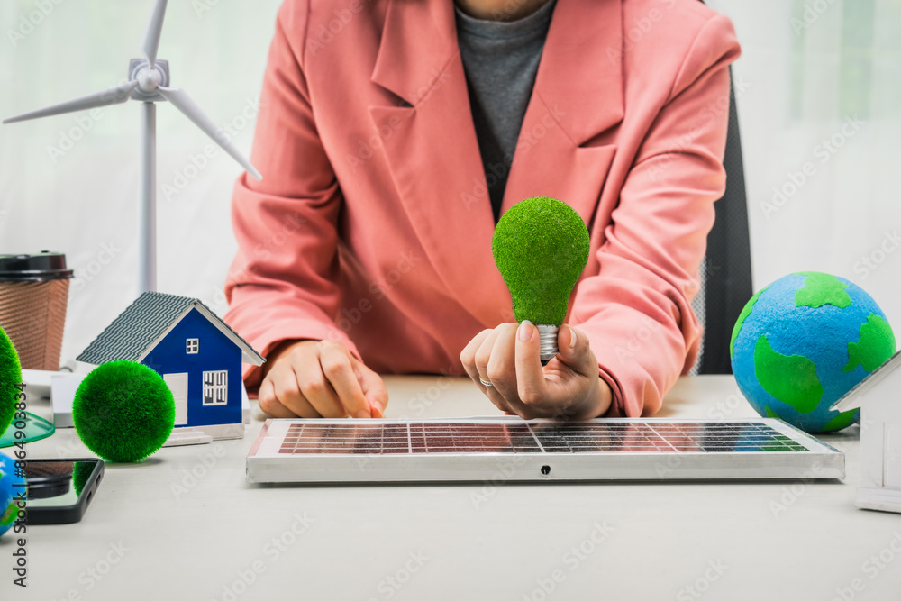 Female entrepreneur working at desk in clean energy sector Focusing on ...
