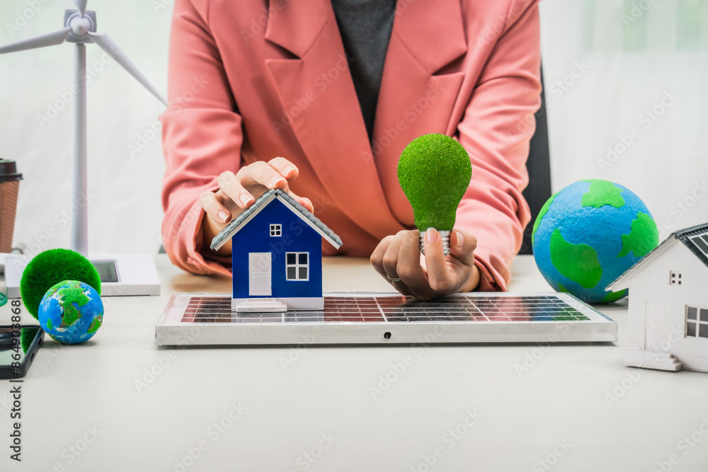 Female entrepreneur working at desk in clean energy sector Focusing on ...