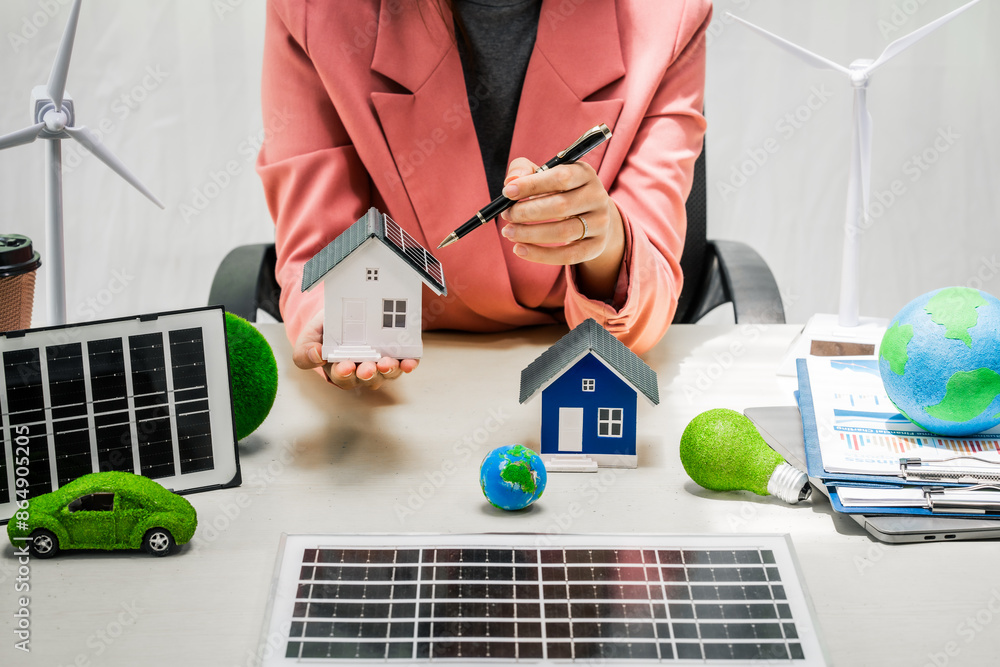 Female entrepreneur working at desk in clean energy sector Focusing on ...