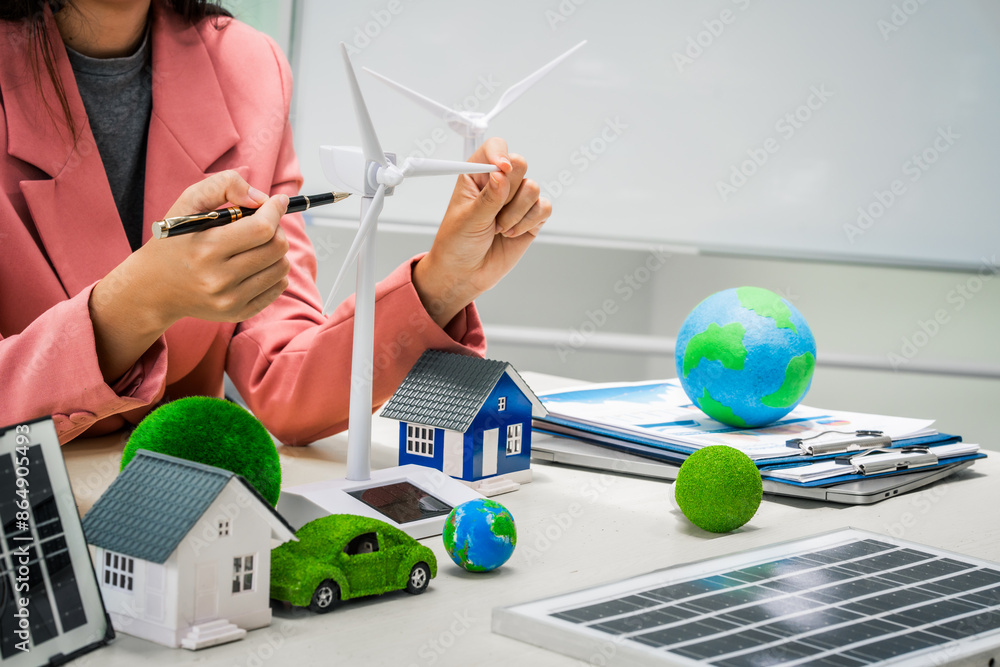 Female entrepreneur working at desk in clean energy sector Focusing on ...