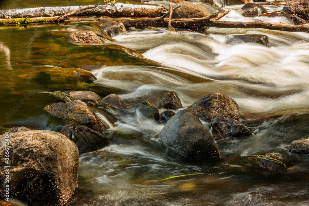 The Manitowish River, near Boulder Junction, Wisconsin flows quickly ...
