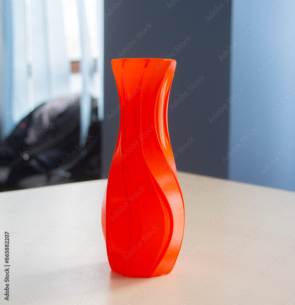 Object in the form of a vase of red color printed on a 3D printer ...