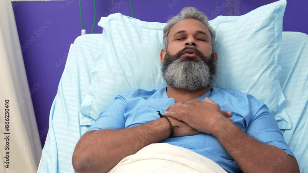 Indian male patient suffer chest pain while lying in hospital bed ...