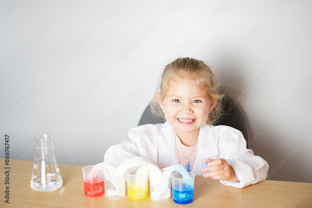 Smiling little girl doing a science experiment. Kindergarten. Education ...