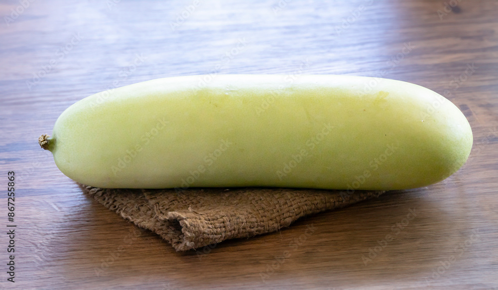 The large green fruits of Benincasa hispida or Wax gourd are a ...