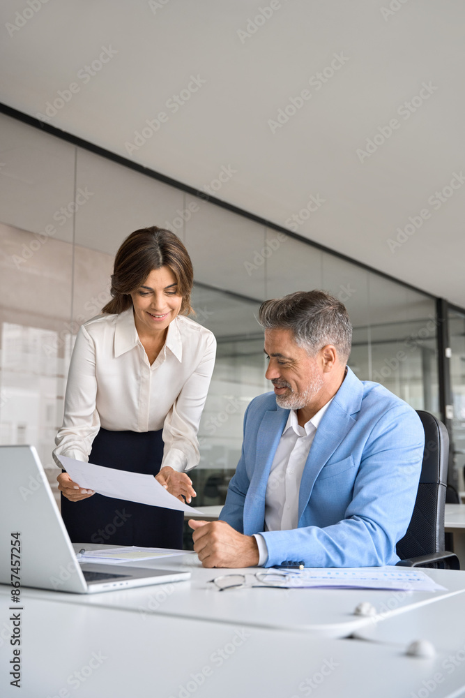 Two happy busy middle aged professionals man and woman business leaders ...