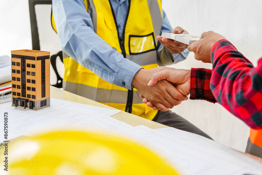 Two men, including a male Asian construction contractor engineer ...