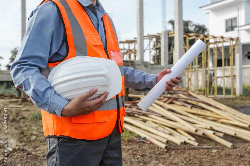 Male Asian construction contractor engineer checks structural plans ...