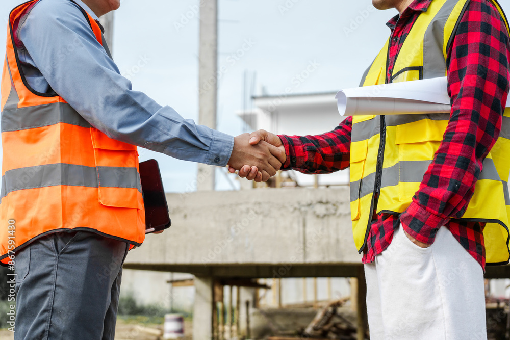 Two male construction workers, including an Asian engineer ...