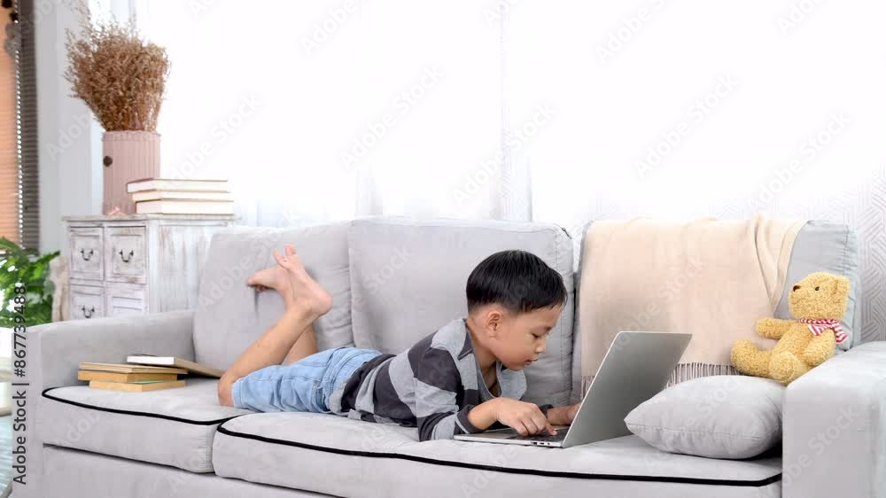 Asian little boy addicted to modern technology laptop connected to ...