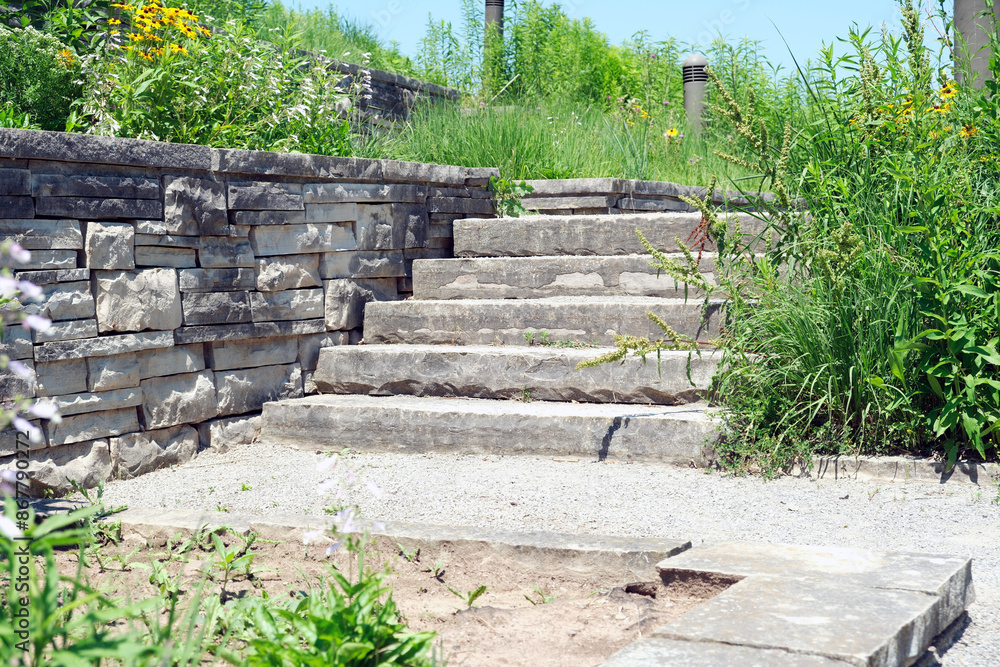 Luxury landscaping with natural stone retaining wall and coping, wide ...