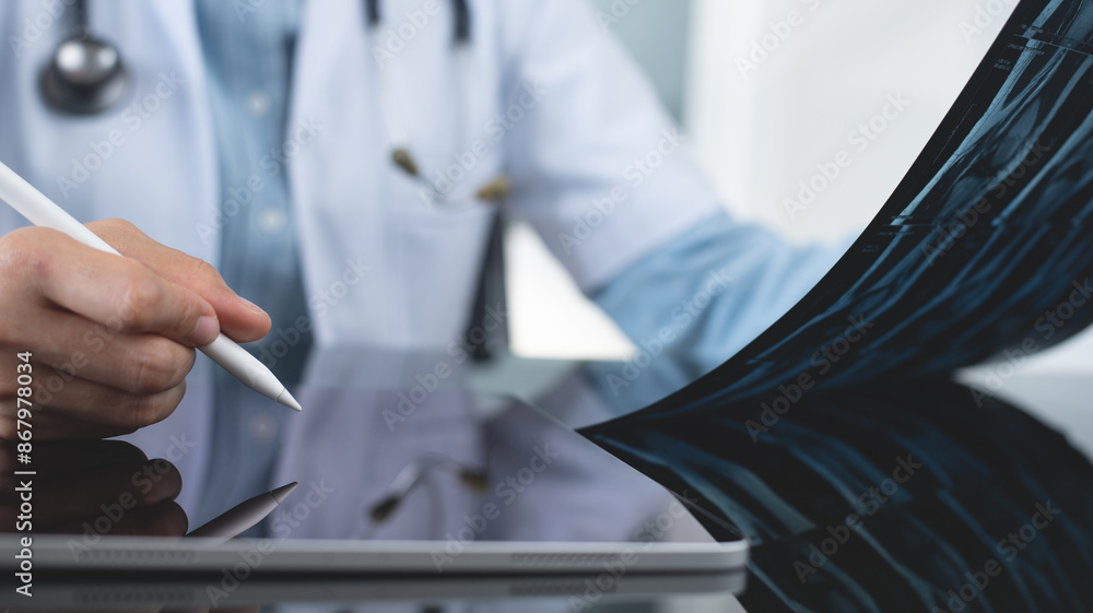 Orthopedics surgeon doctor using digital tablet and examining and ...