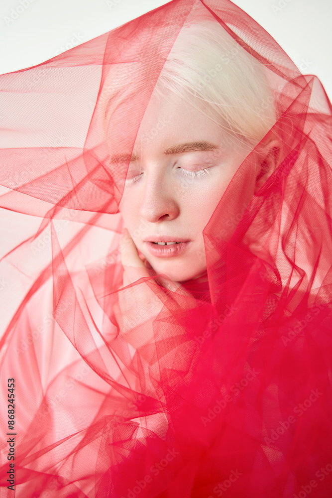 Inclusive beautiful albino woman wearing red veil on white background ...