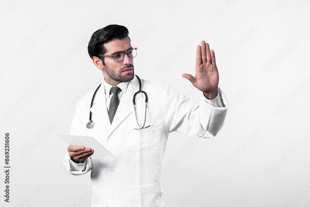 Caucasian smart doctor pointing finger while standing at white ...