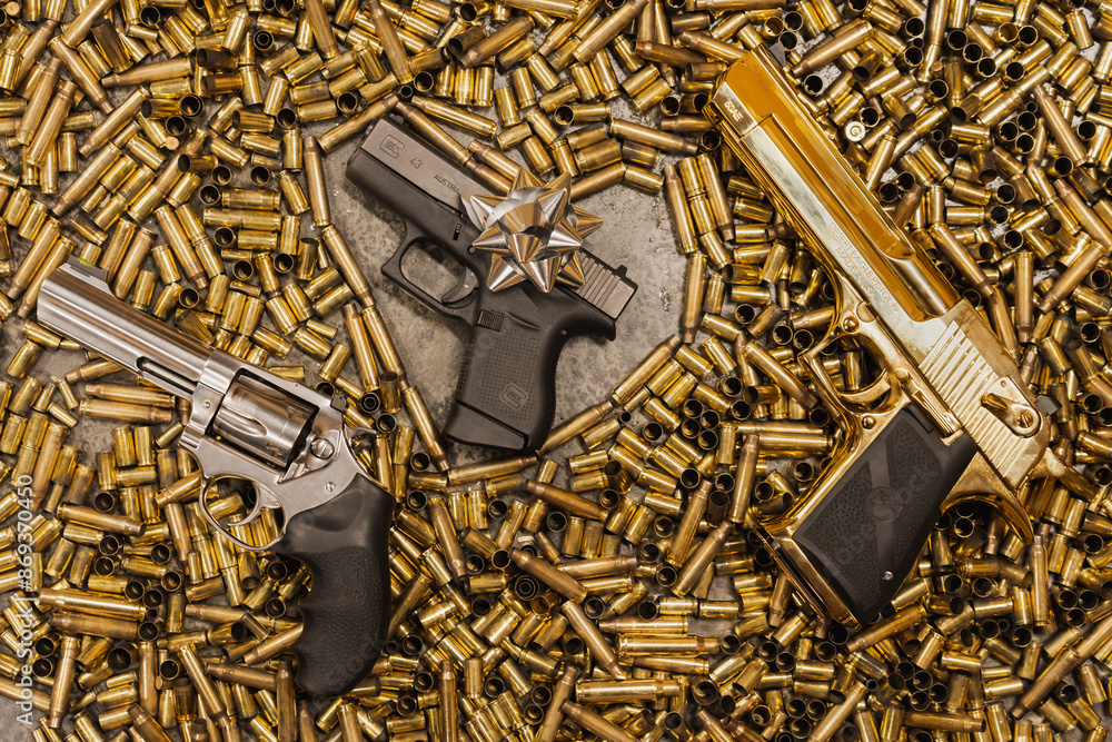Baltic States, May 6, 2024. A gold Desert Eagle pistol, a ruger gp100 ...