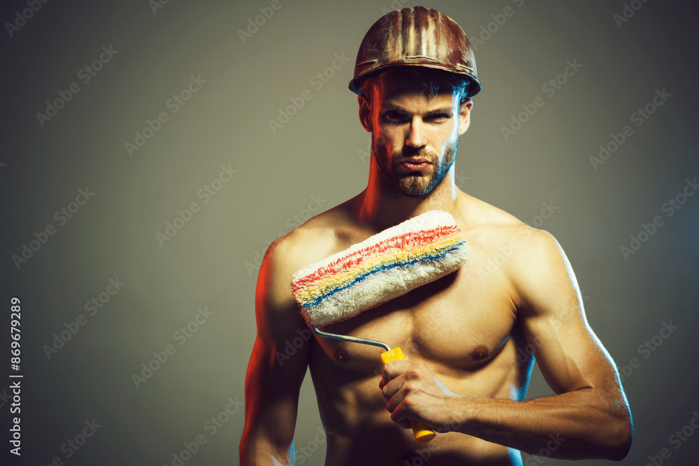 Professional painter man in hard hat with paint roller. Confident ...