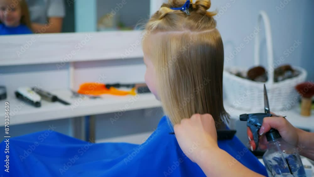 Girl blonde having haircut at the salon. Haircut for long hair under ...