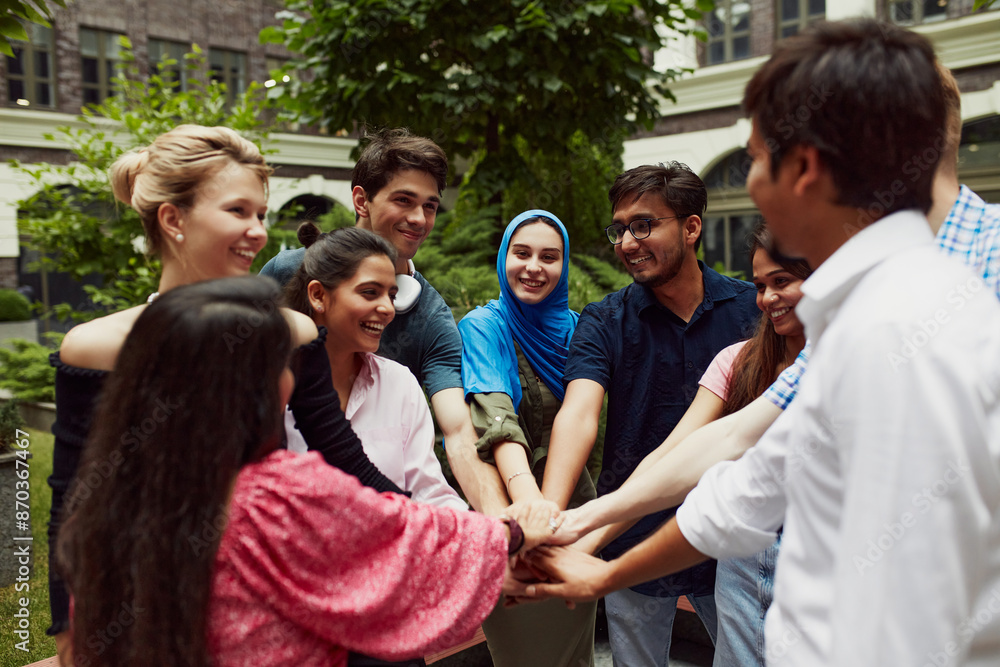 Smiling students of varied ethnicities supporting each other, holding ...