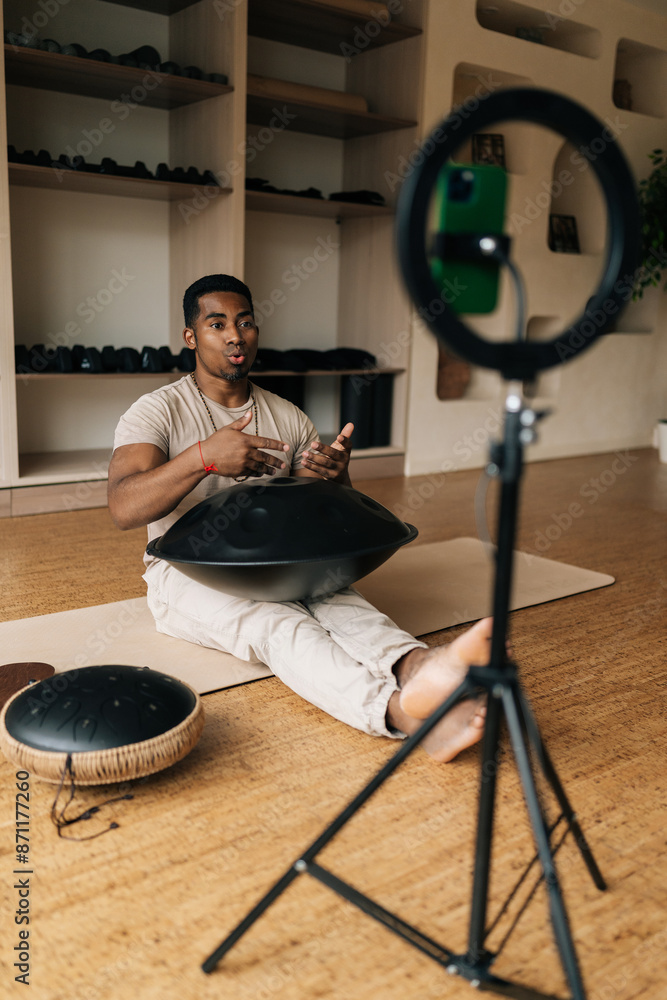 Vertical portrait of black male blogger telling about playing native ...