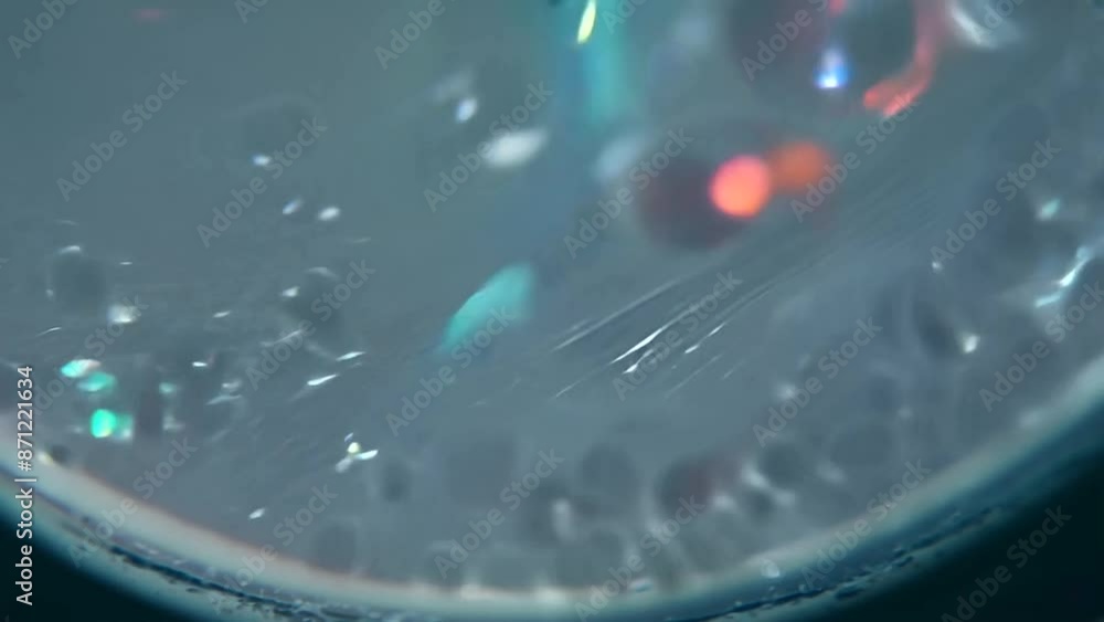 A detailed view of blood cells being analyzed within a flow cytometry ...