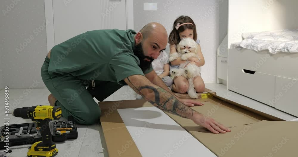 Dad, daughter and son open the boxes for the future bed in the kids ...