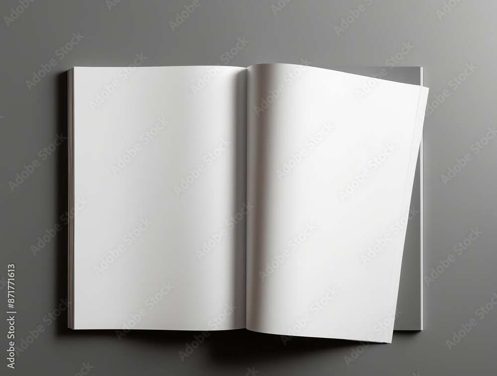 Blank open magazine mockup. The magazine is laid flat on a smooth, grey ...