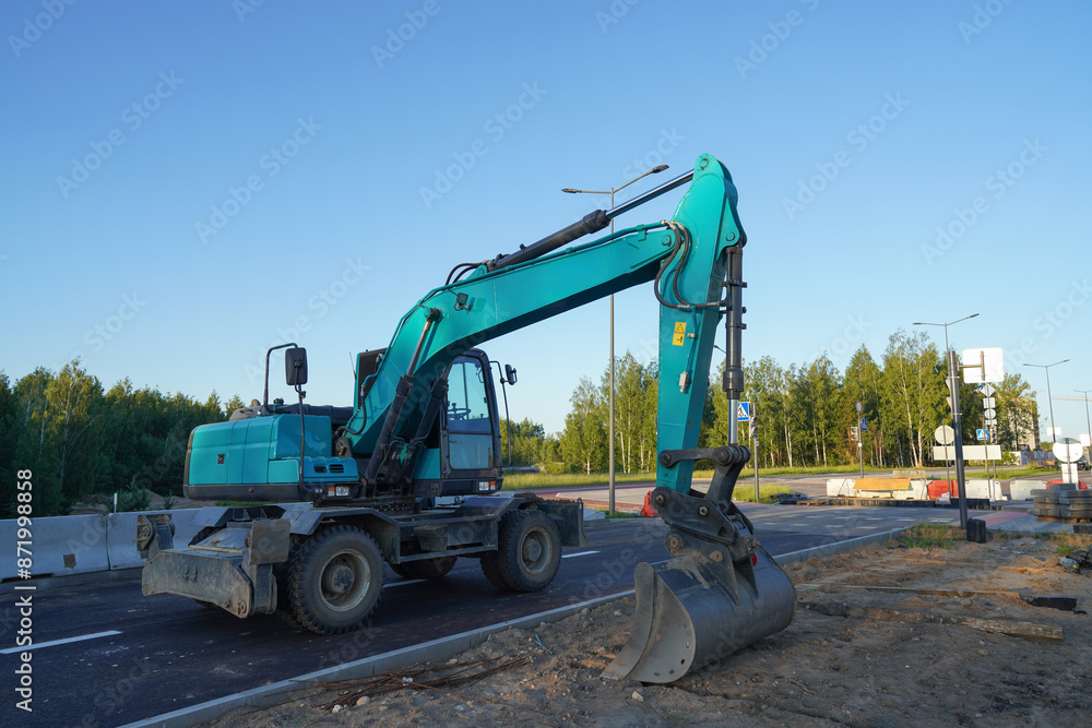 Excavator on road construction. Screeding ground for installing borders ...
