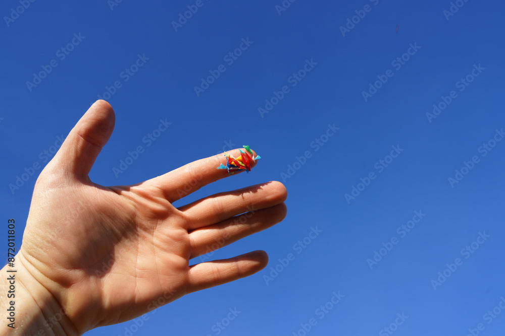 Microplastic pollution. Microplastics Microplastic on finger of hand ...