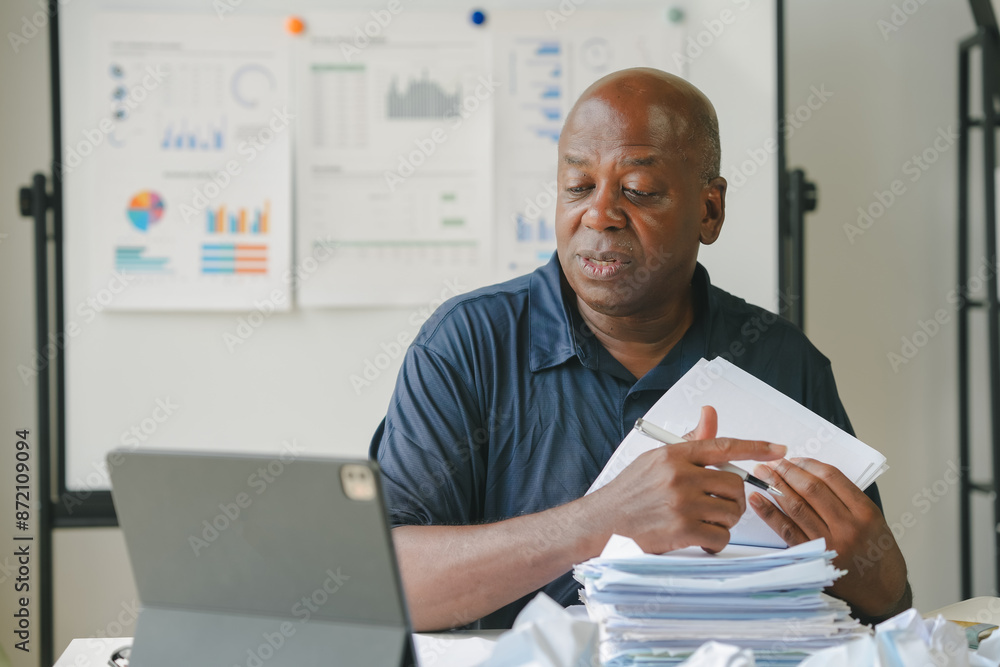 Business professional sorting through paperwork in a modern office ...