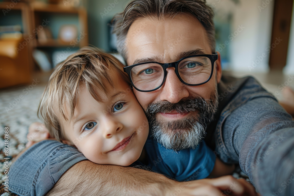 Little boy making selfie on smartphone with father, lying on floor in ...