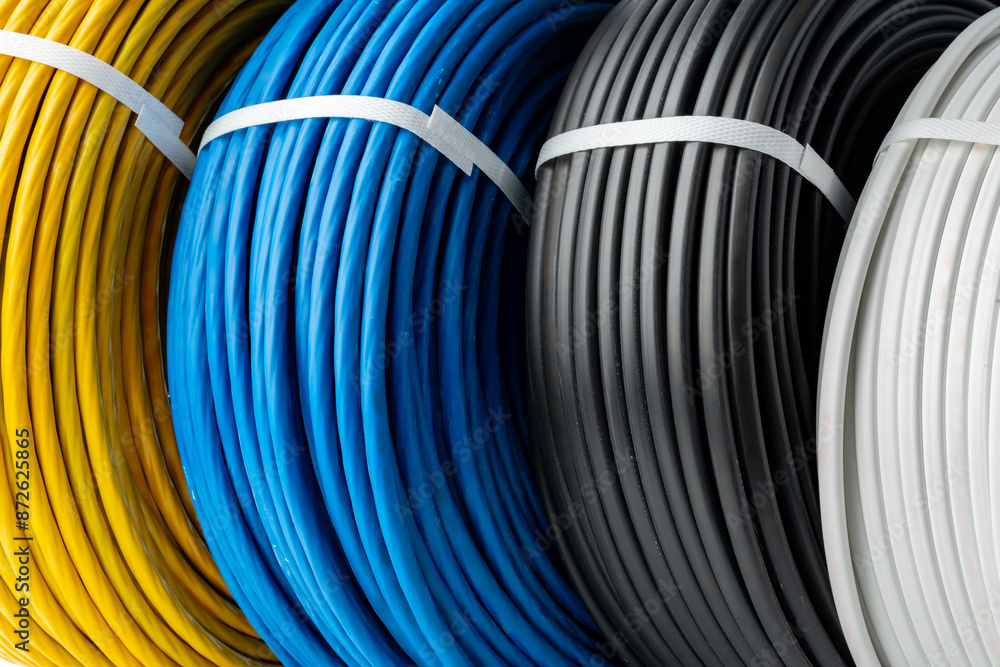 Four Spools of Electrical Wire in Yellow, Blue, Black, and White Colors ...
