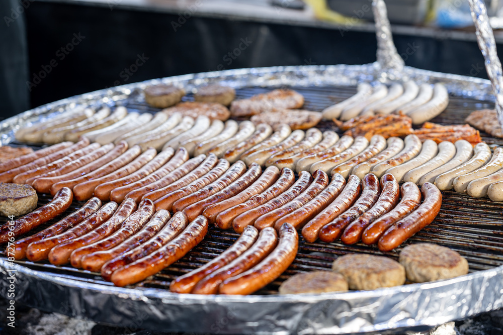 Wurst und Fleisch auf dem Schwenkgrill Stock Photo | Adobe Stock