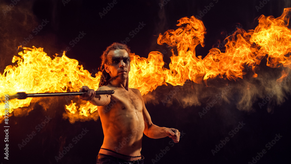 Shirtless Male Fire Performer With Dreadlocks Wields Flaming Staff ...