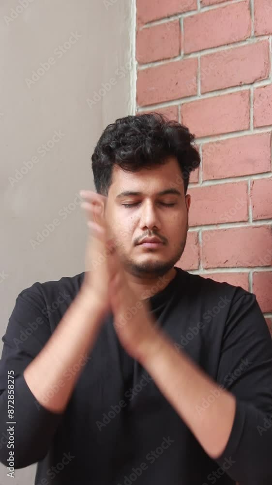 person is rubbing his hand palms and placing on the closed eyes after ...