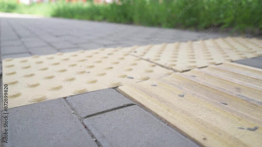 Metropolitan navigation: Elevated view of tactile pavement with braille ...