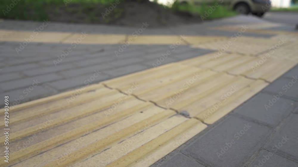 Metropolitan navigation: Elevated view of tactile pavement with braille ...