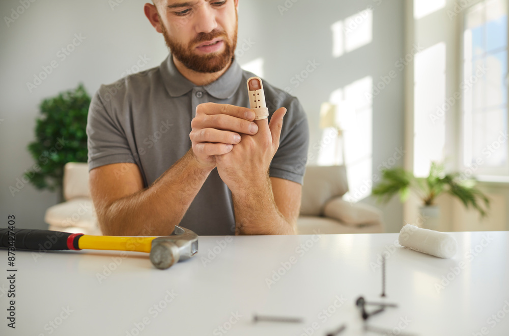 Injured man puts on adjustable finger splint brace after working with ...