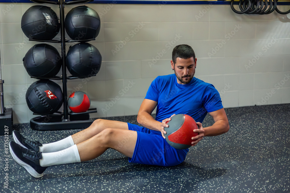 sportsman performs core rotations to train abdominal muscles with ...