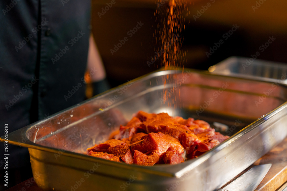 close up n a restaurant in a rib bar in the central hall a chef in ...